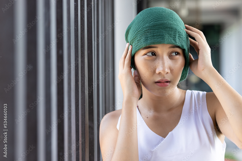 Sad and depressed asian woman cancer patient suffering from alopecia ...