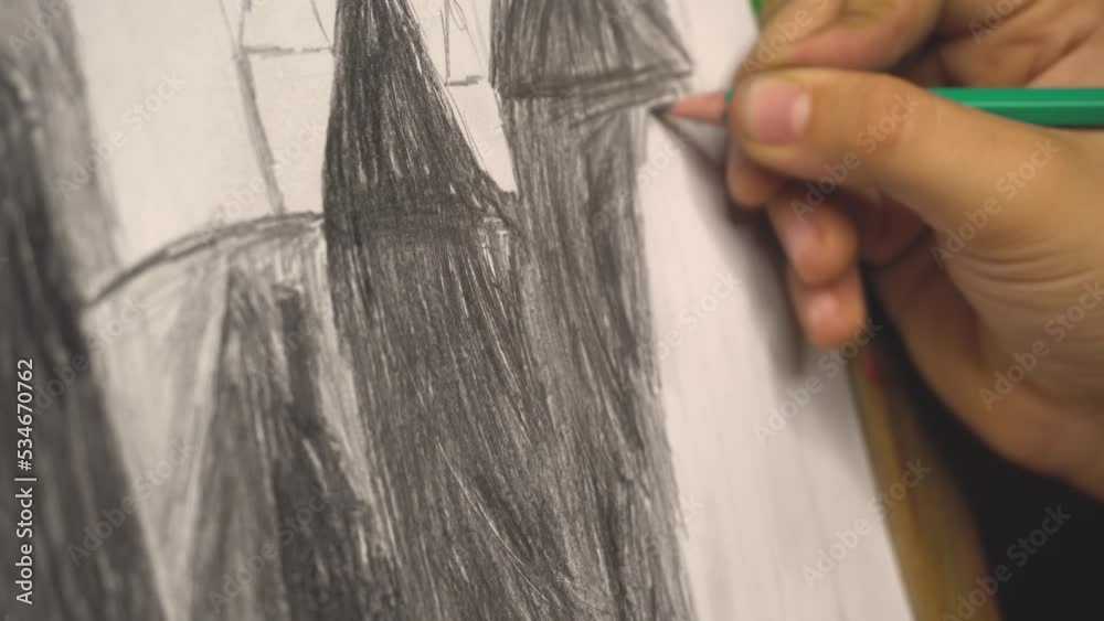 the child draws with hatching. simple pencil drawing Close up painter ...