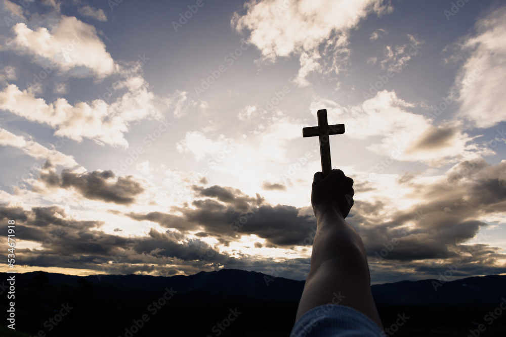 Silhouette of woman hands praying with cross in nature sunrise ...