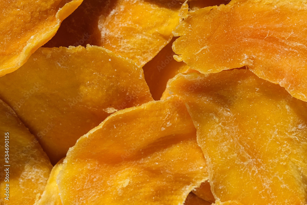 Dried mango slices close-up on a white. Top view. Closeup. Mango chips ...