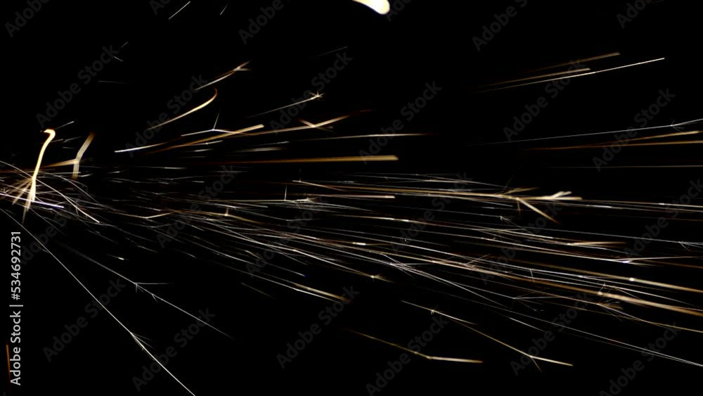 Bright sparks on a black background. Sparks of fire fly and fall. Cut ...