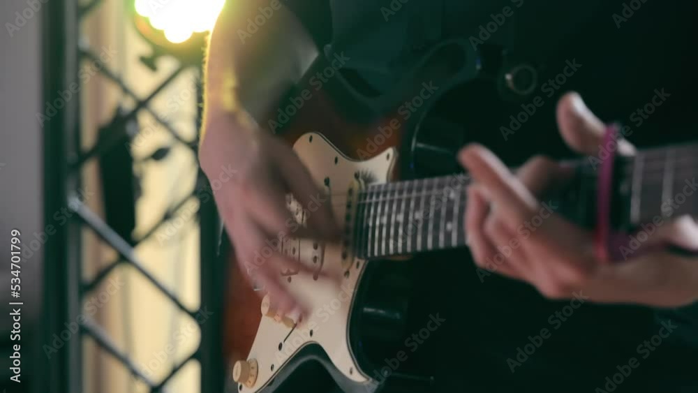 Dynamic electric guitar playing close-up during a concert. The musician ...