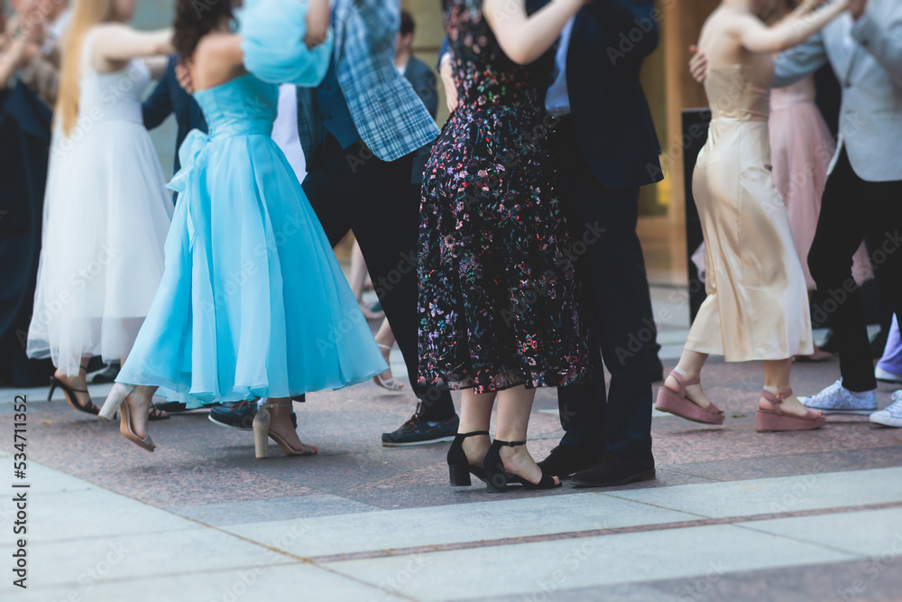 High school graduates dancing waltz and classical ball dance in dresses ...
