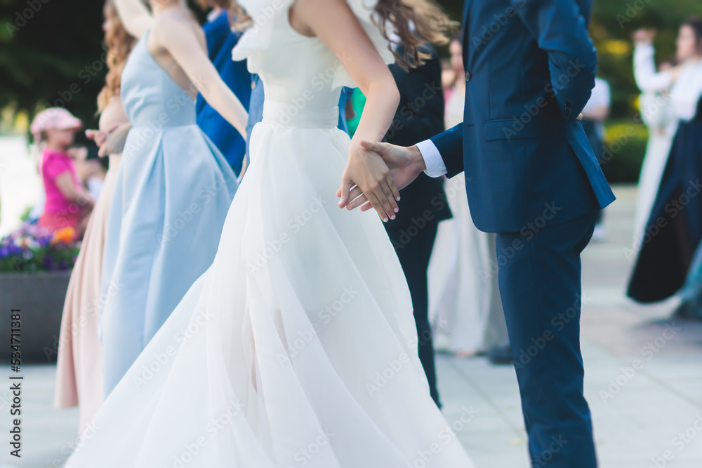 High school graduates dancing waltz and classical ball dance in dresses ...
