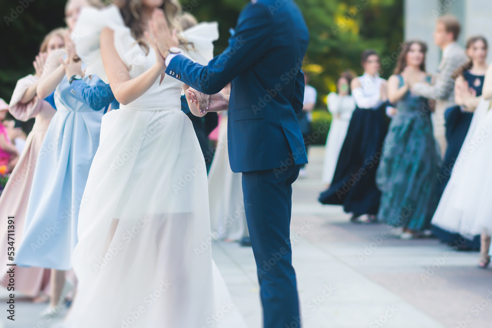 High school graduates dancing waltz and classical ball dance in dresses ...