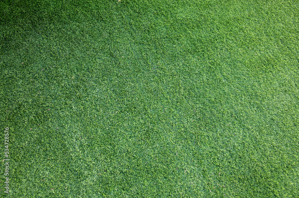 The surface of the artificial grass background with copy space. Top ...