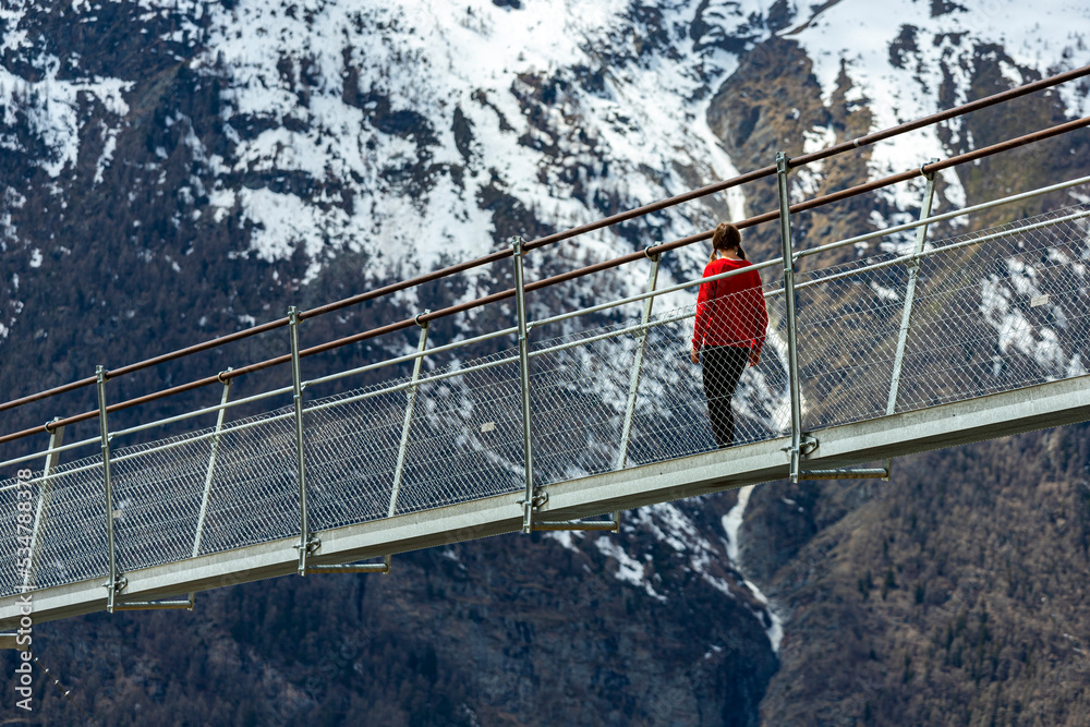 Girl in pigtails walks across the longest suspension bridge in the ...
