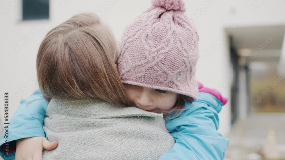 Young mom, kid, daughter are hugging in autumn in park. Kid, daughter ...
