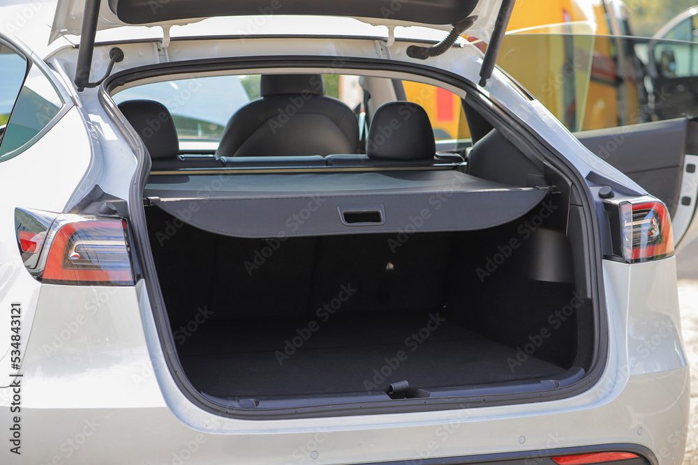 Rear view of car Tesla Model Y with open trunk Stock Photo | Adobe Stock