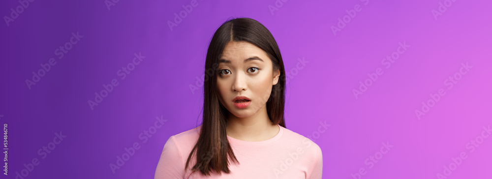 Close-up confused shocked cute young silly asian girl hear strange ...