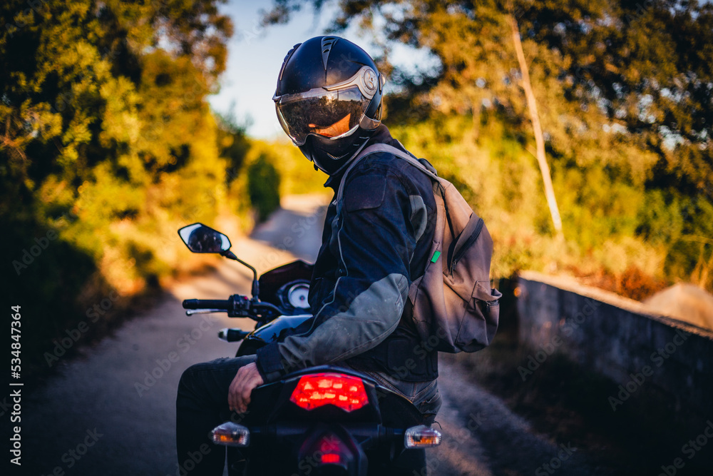 biker on motorcycle looking back searchung his friends in the N2 route ...