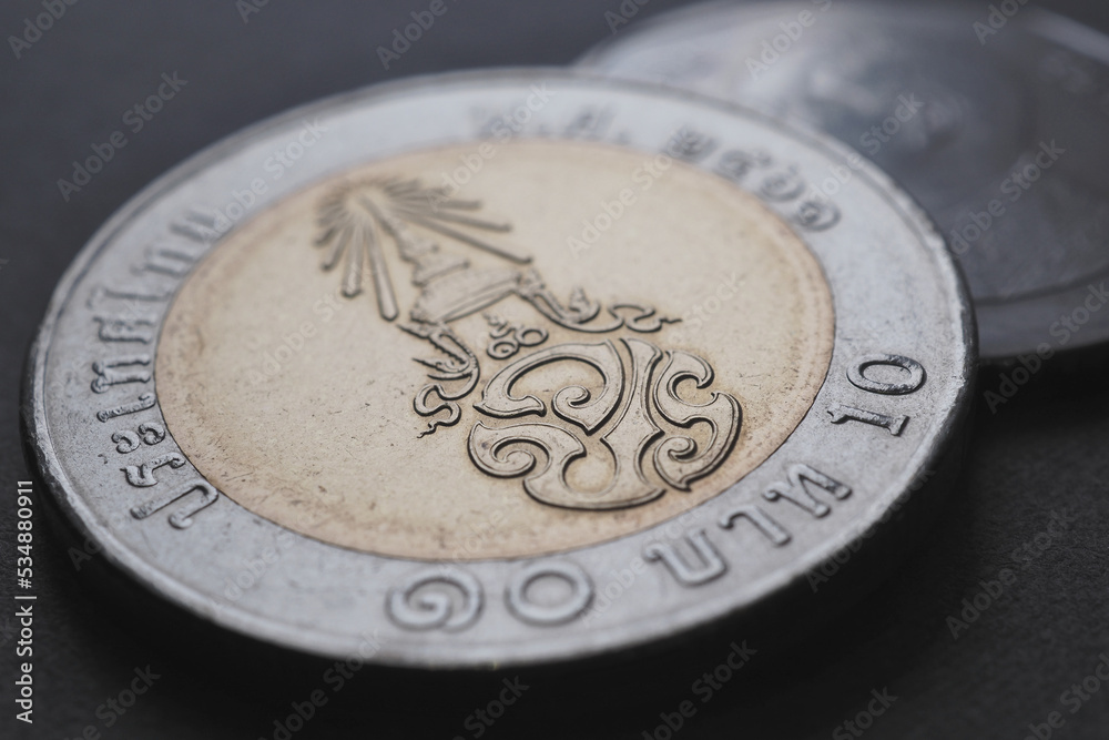 Translation: 10 baht Thailand. Thai coin of 10 baht. Light background ...