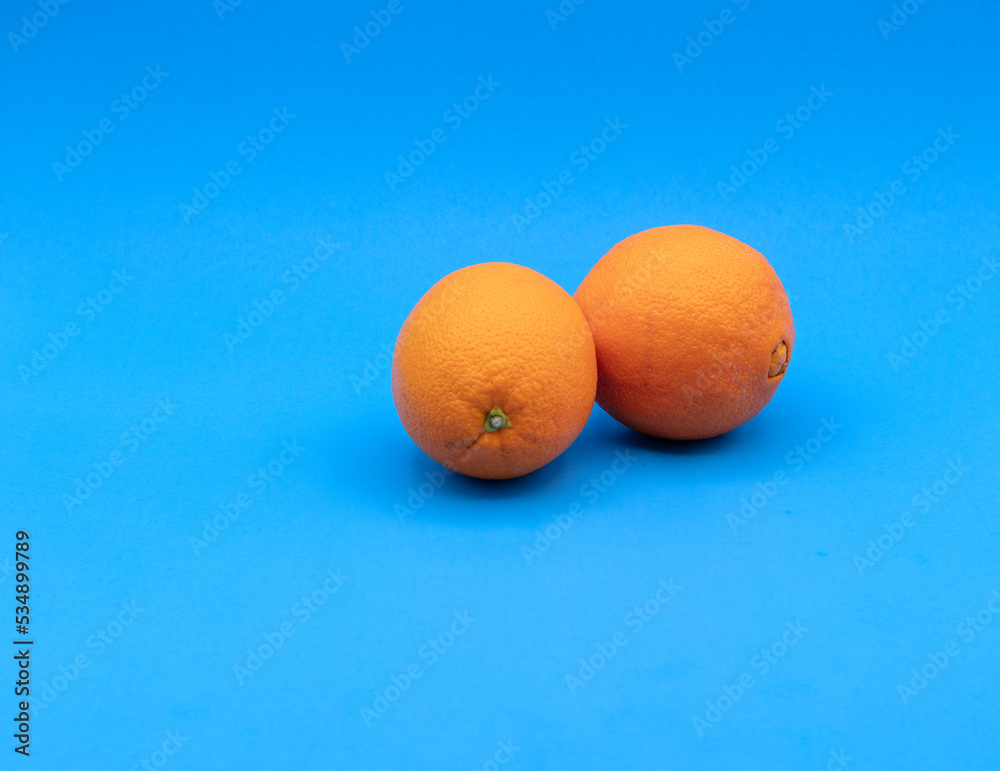 ORANGES ON A BLUE BACKGROUND Stock Photo | Adobe Stock