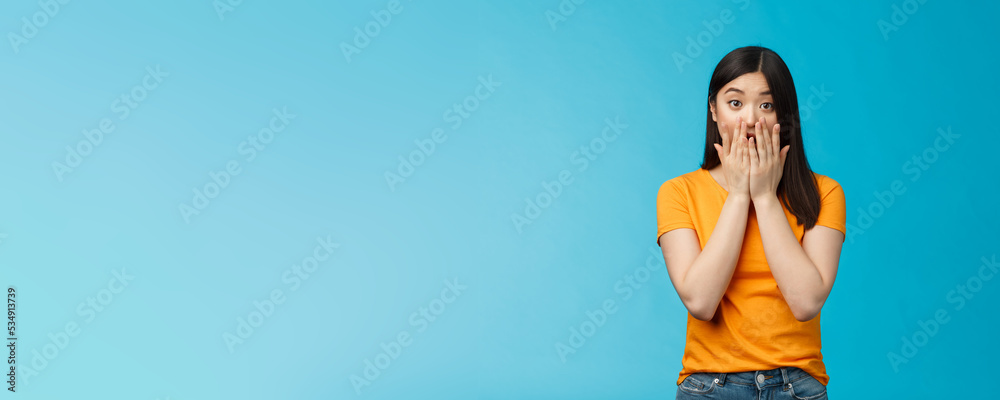 Shocked speechless stunned asian girl stare camera cover mouth palms ...