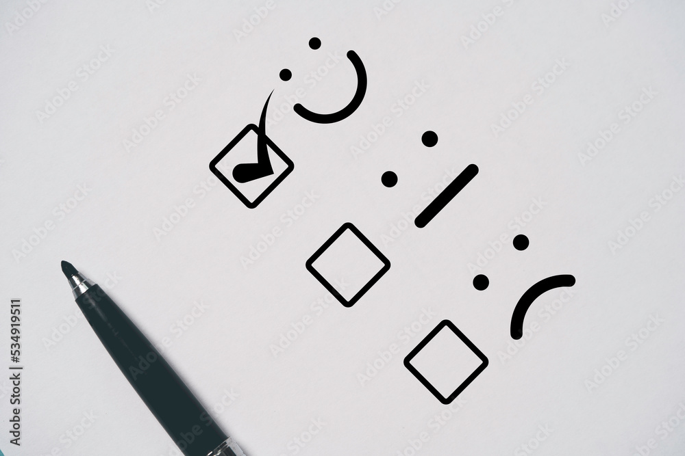 User use pen to check mark select smile face for customer evaluation ...