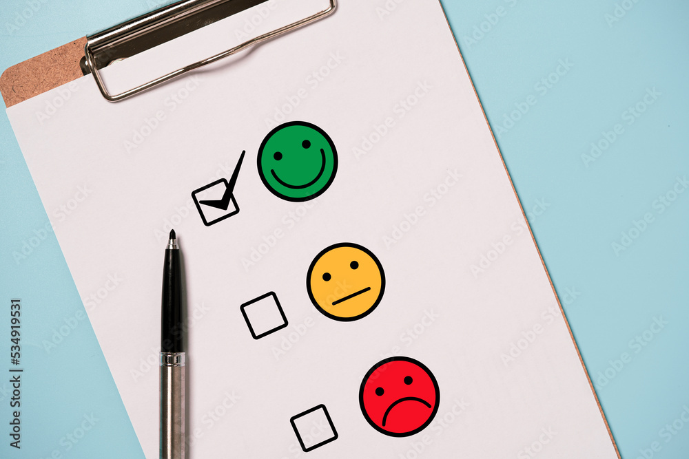 User use pen to check mark select smile face for customer evaluation ...