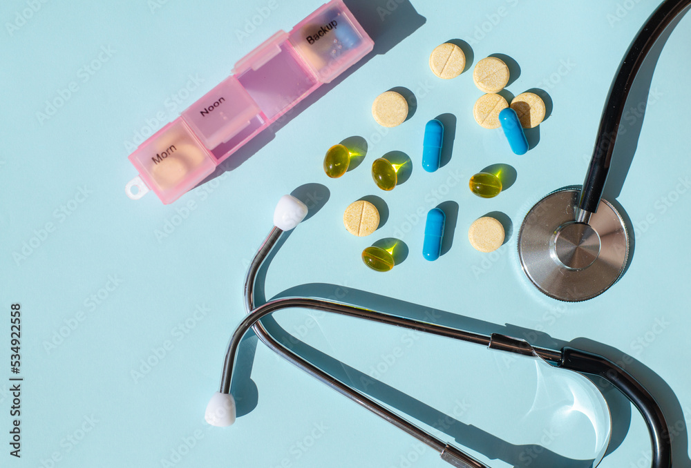 The stethoscope is on the table. Tablets and capsules with medicine on ...