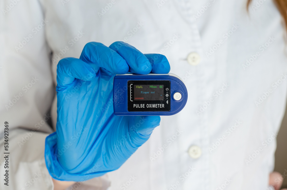 Pulse oximeter. Medical device on the finger. Patient diagnosis. Covid ...