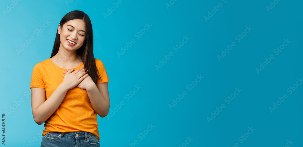 Lovely asian woman with dark haircut close eyes press hands heart ...