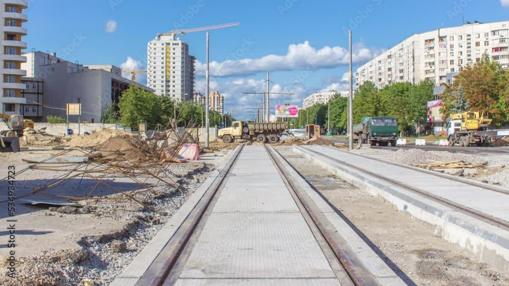 Workers do cleaning of the railway tram line after construction works ...