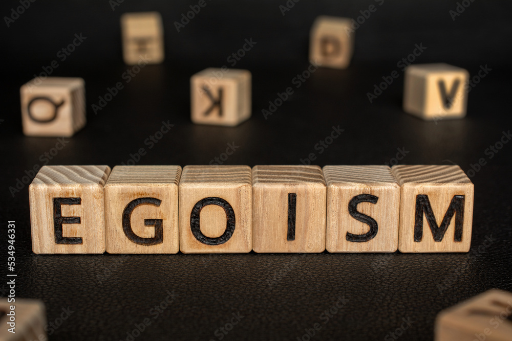 Egoism - word from wooden blocks with letters, an undue sense of self ...