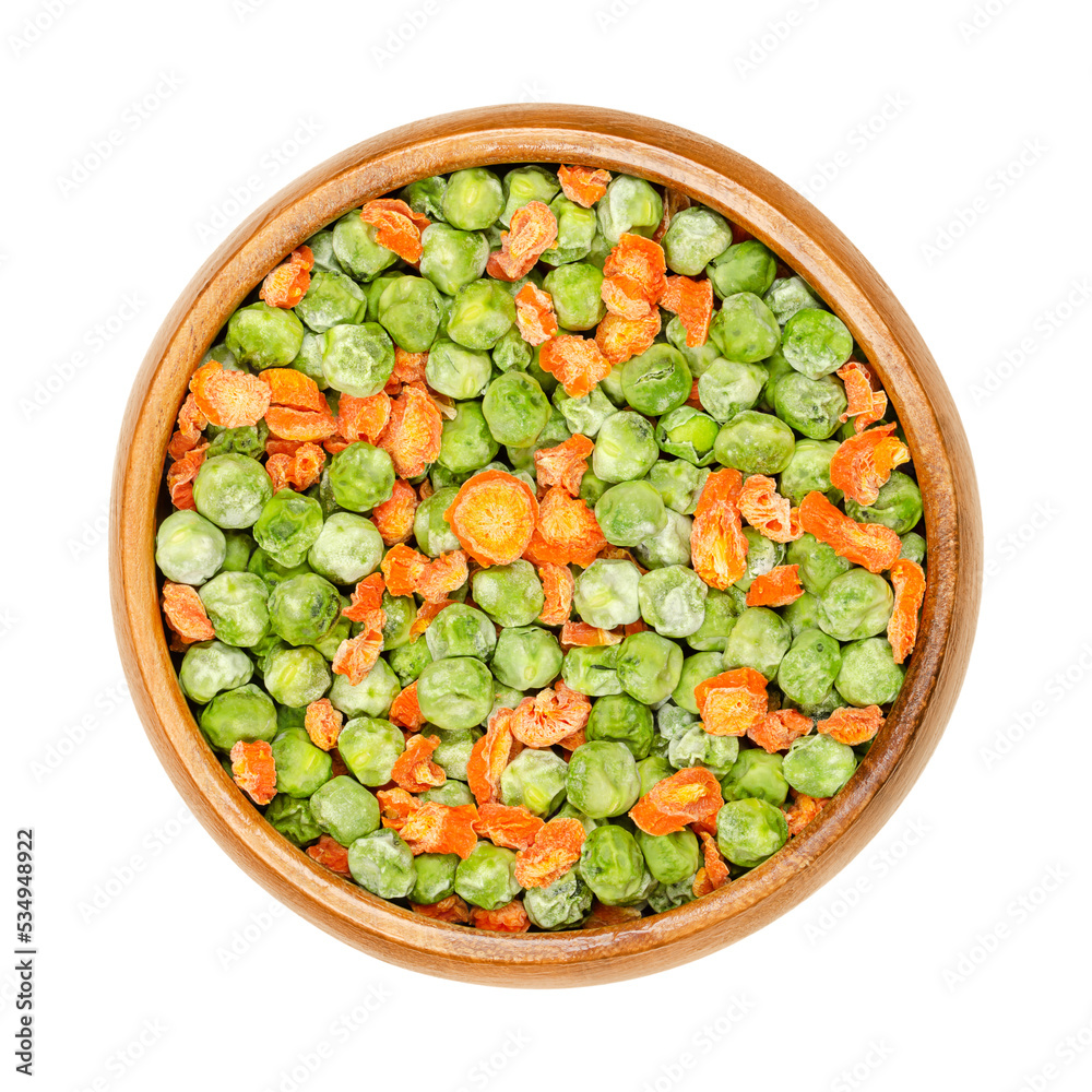 Dehydrated green peas and carrot pieces in a wooden bowl. Mixed ...