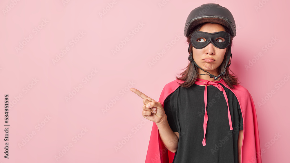 Horizontal shot of Asian woman with dark hair has sad facial expression ...