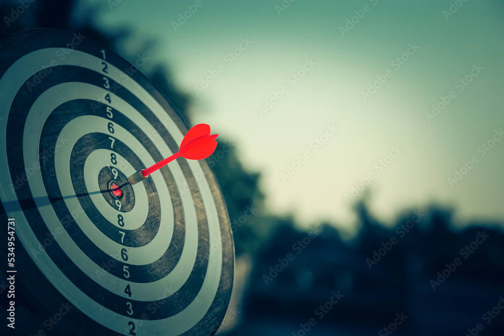 bullseye target or dart board has red dart arrow throw hitting the ...