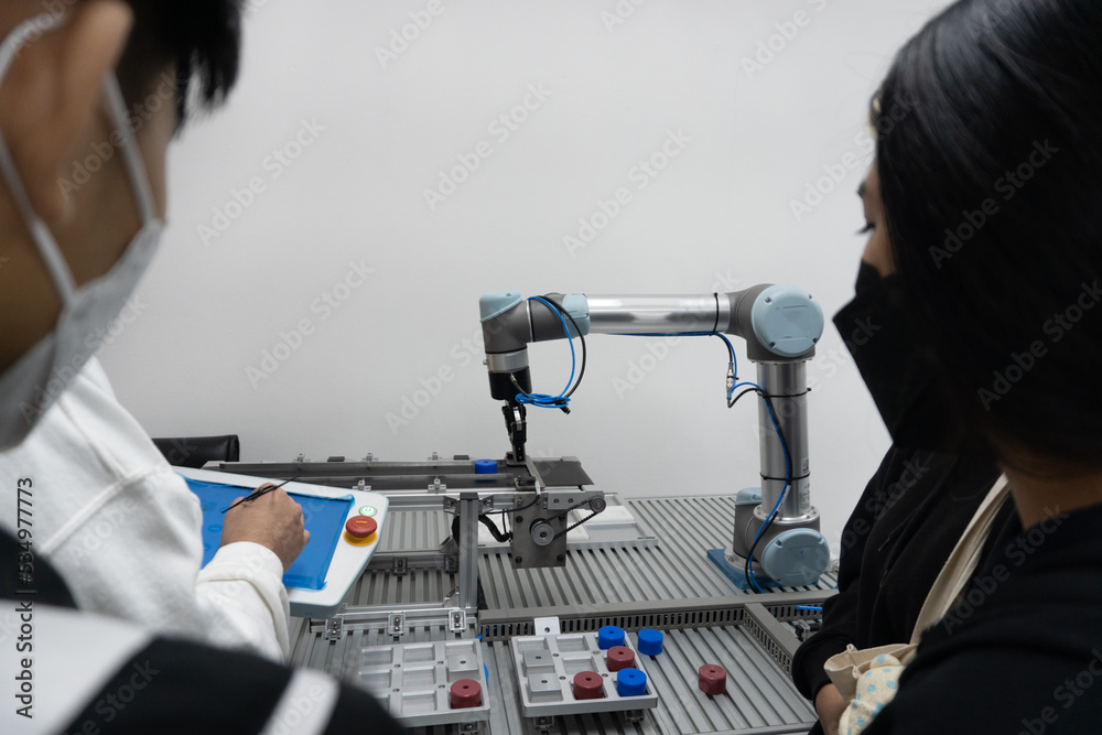 Asian Student study Robotic Arm with Screwdriver During the Lesson ...