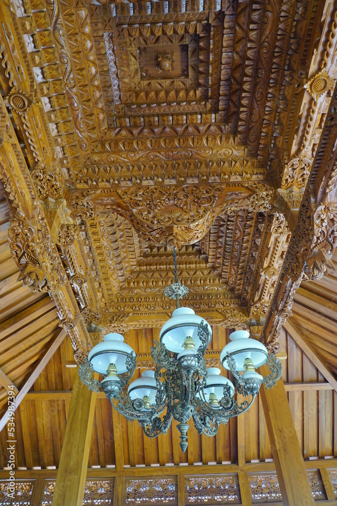 Old Javanese chandelier inside a joglo house. Javanese hanging lamp ...