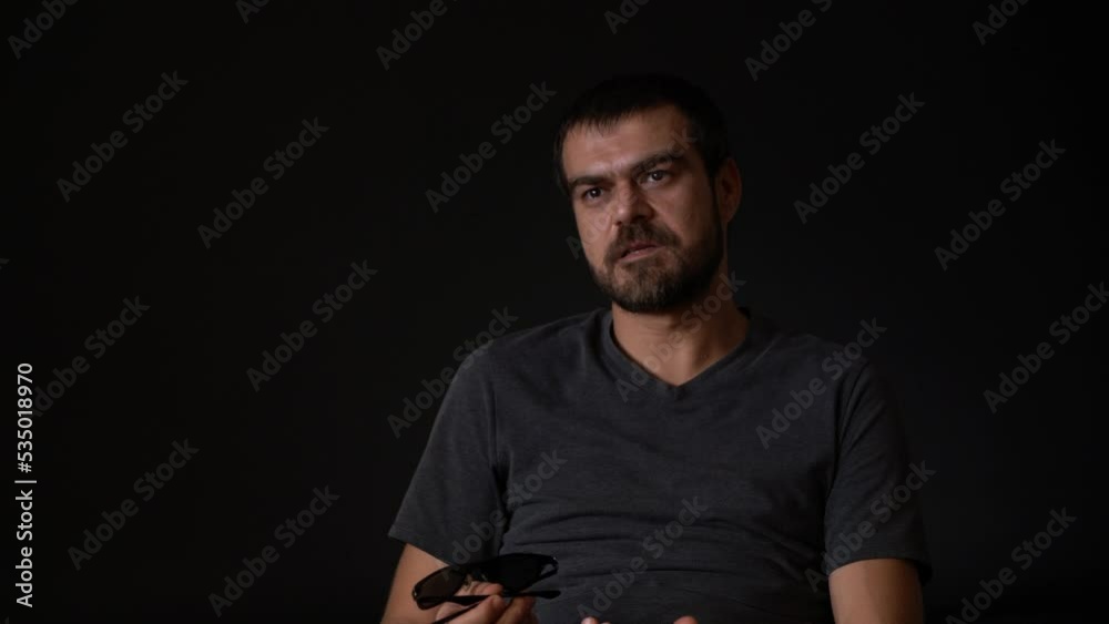 Interview video of a man with dramatic light on black background. Stock ...