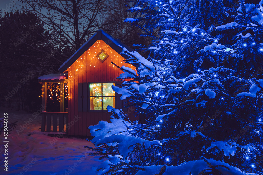 Photo Art Print Cute wood play house in home garden decorated with Christmas LED string lights outdoors in cold winder night FotoHelin