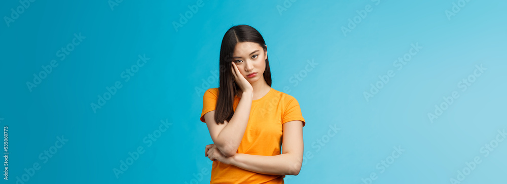 Sad bored asian female student attend boring uninteresting lecture lean ...