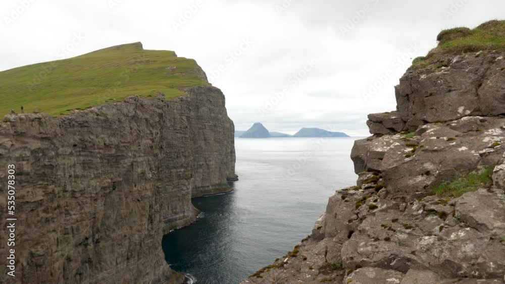 A gap in the rock. A huge mountain or a rock formation next to a ...