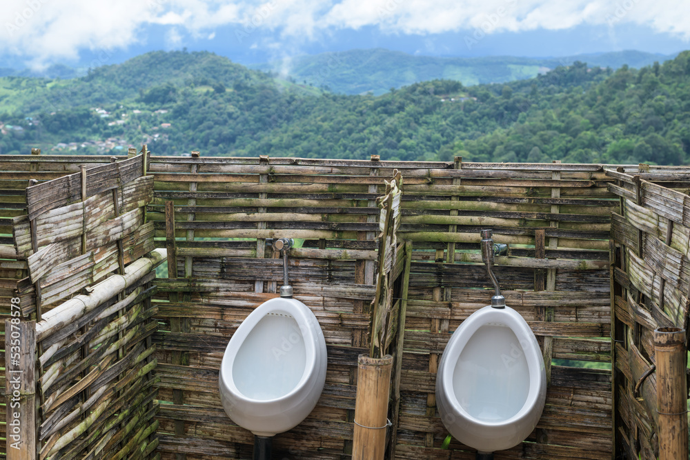 Row of outdoor urinals men public toilet with nature background Stock ...