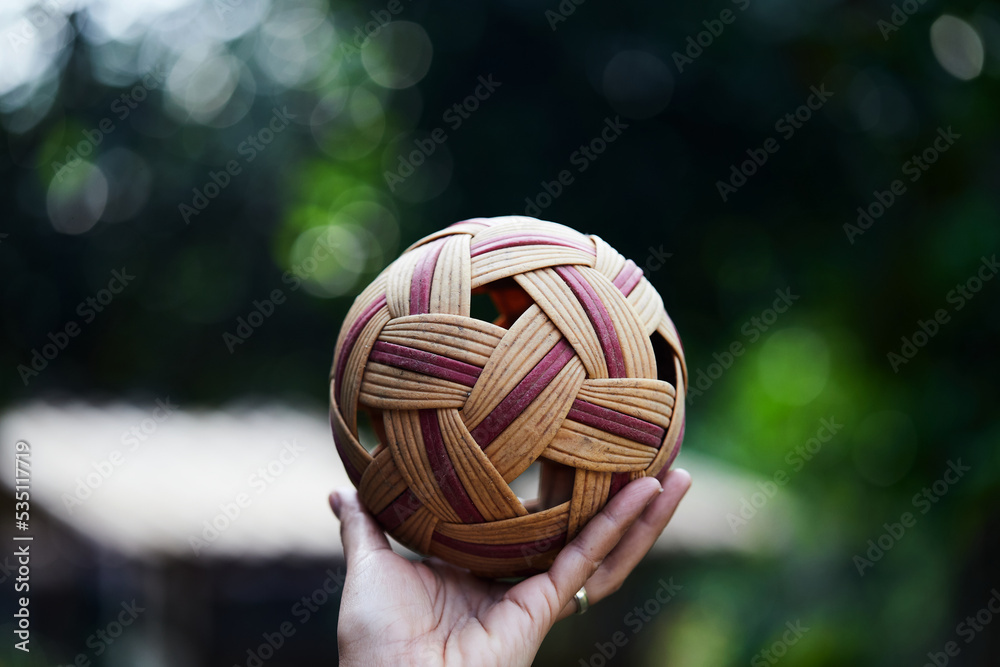 Hand holding Sepak takraw ball Stock Photo | Adobe Stock