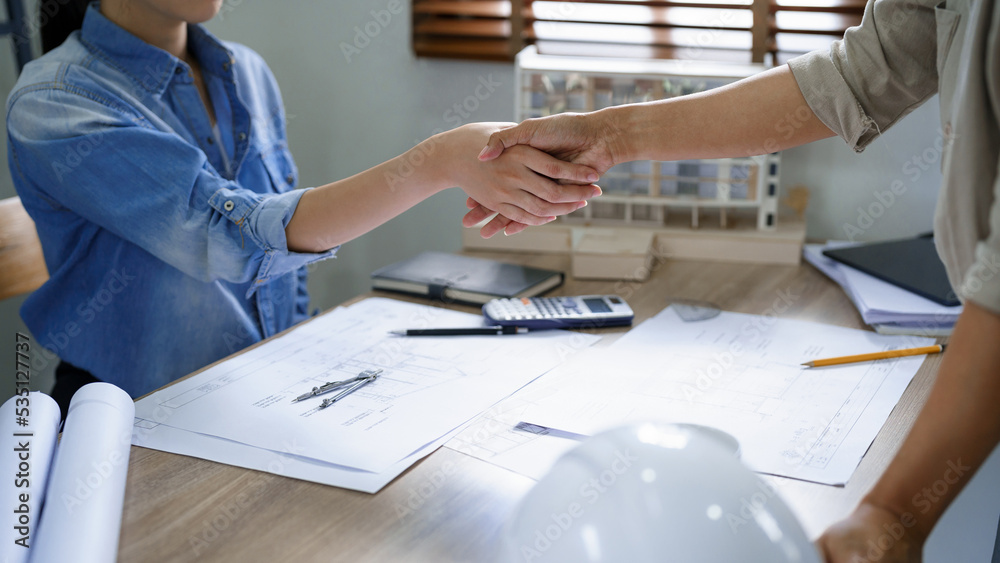 Engineering construction concept, Two female engineers shake hands ...