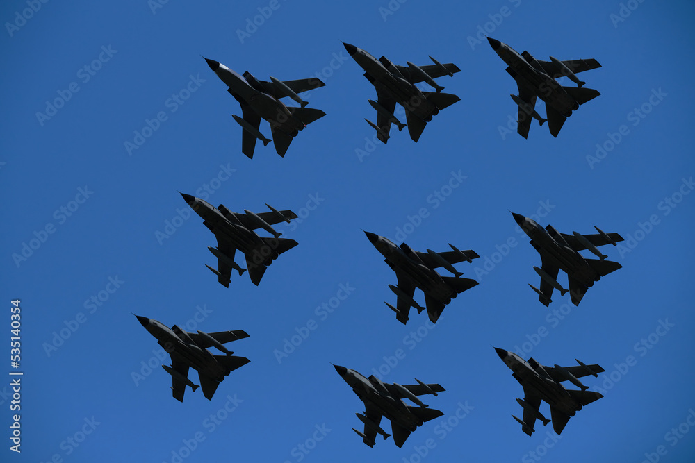 Silhouettes of nine military interceptor aircraft in flight, bottom ...