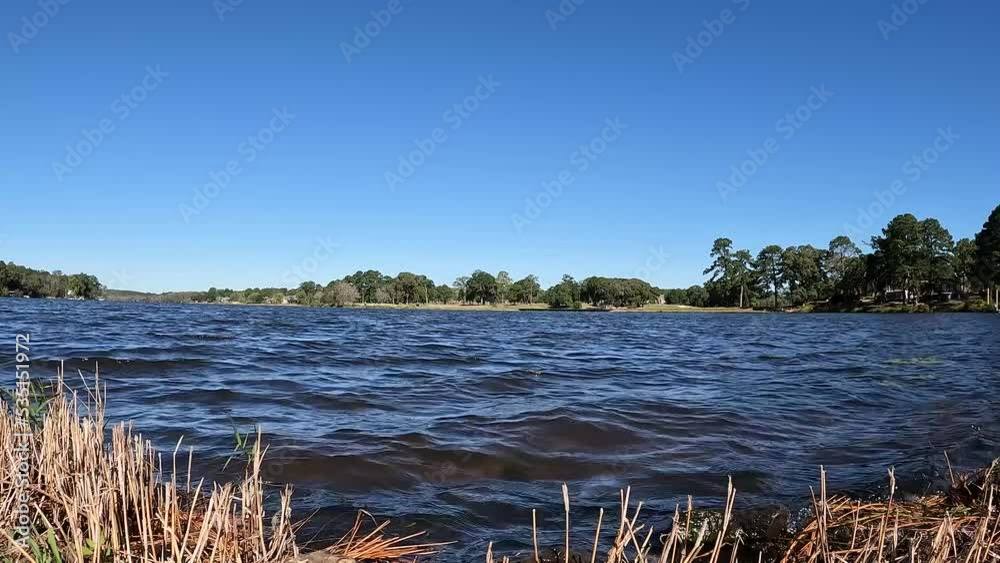footage of a gorgeous autumn landscape at Houston Lake with rippling ...