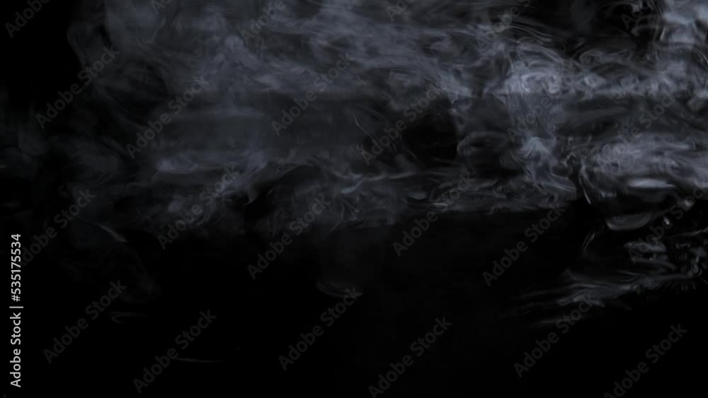 Vidéo Stock a medium amount of smoke floating in the air dissapearing ...