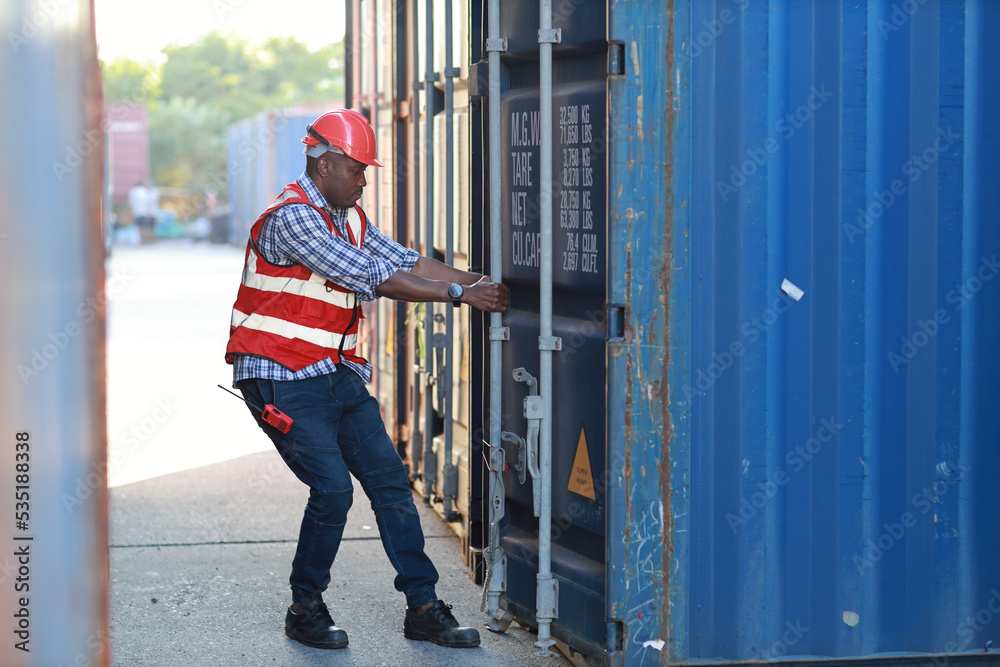 Foreman opens container door to view goods inside and control loading ...