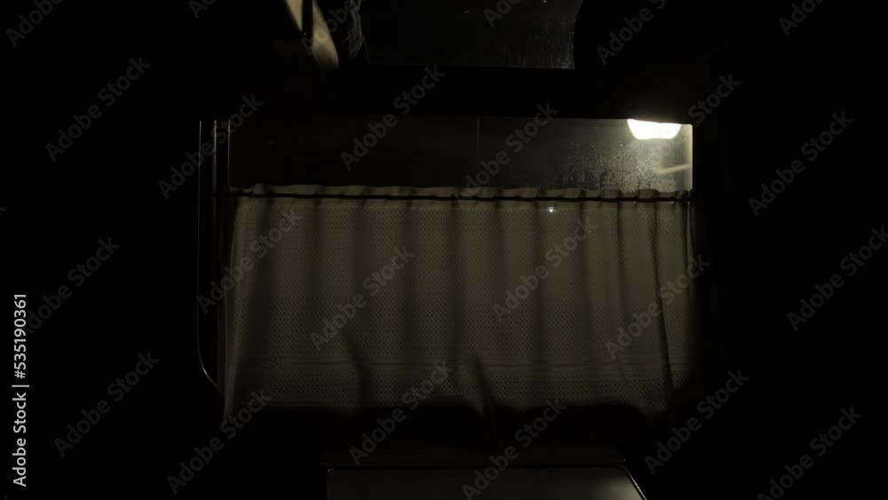 Inside dark compartment of corridor coach of railway passenger train at ...