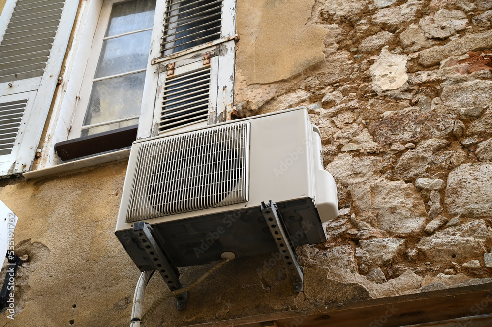 Air conditioning system installed on the facade of an old dwelling ...