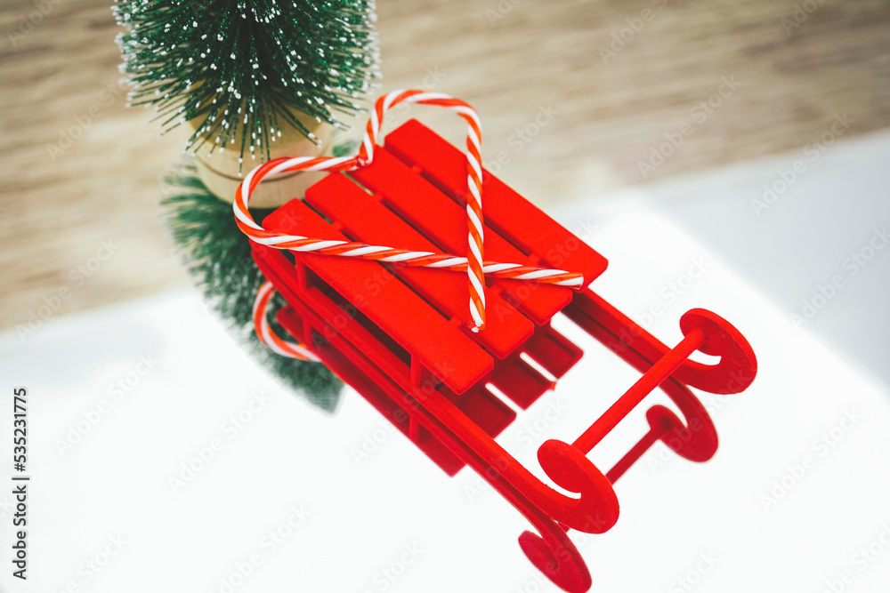Classic christmas background with a red sled and a christmas tree over ...