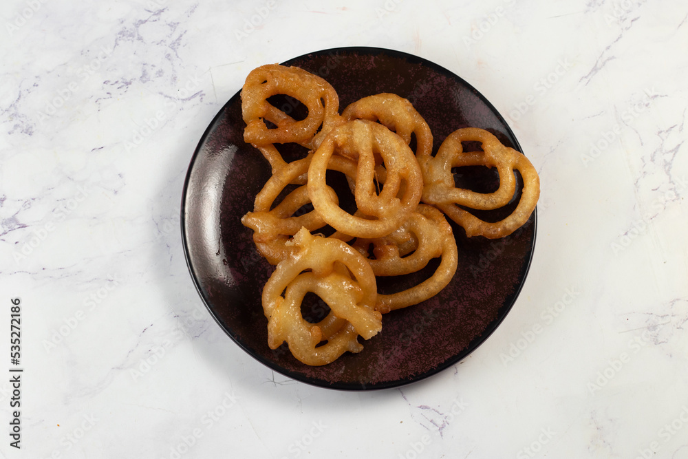 indian sweets deep fired jalebi, jilipi, jilabi served in a dish ...