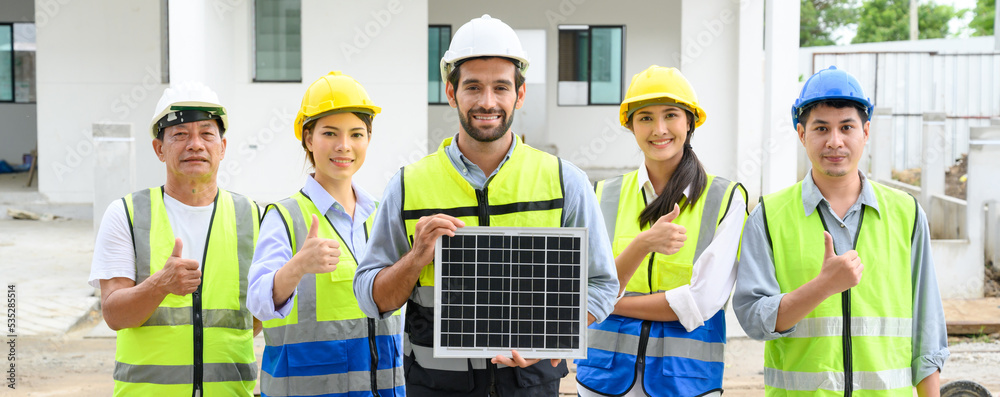 electrician man in vest with helmet showing solar cell panel with the ...