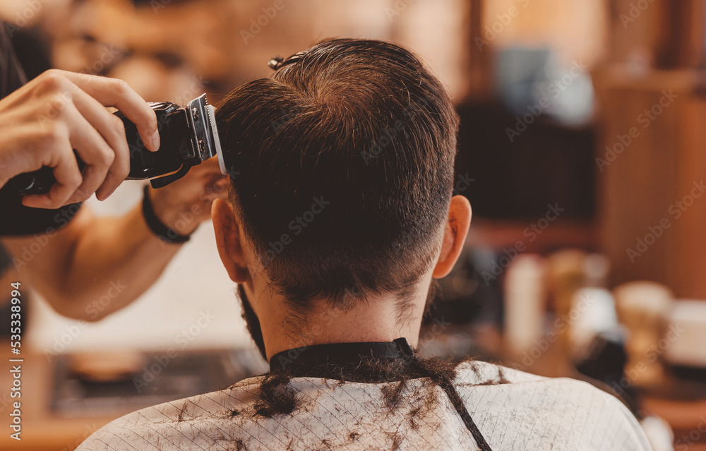 Barbershop concept, vintage color. Closeup man haircut, master does ...