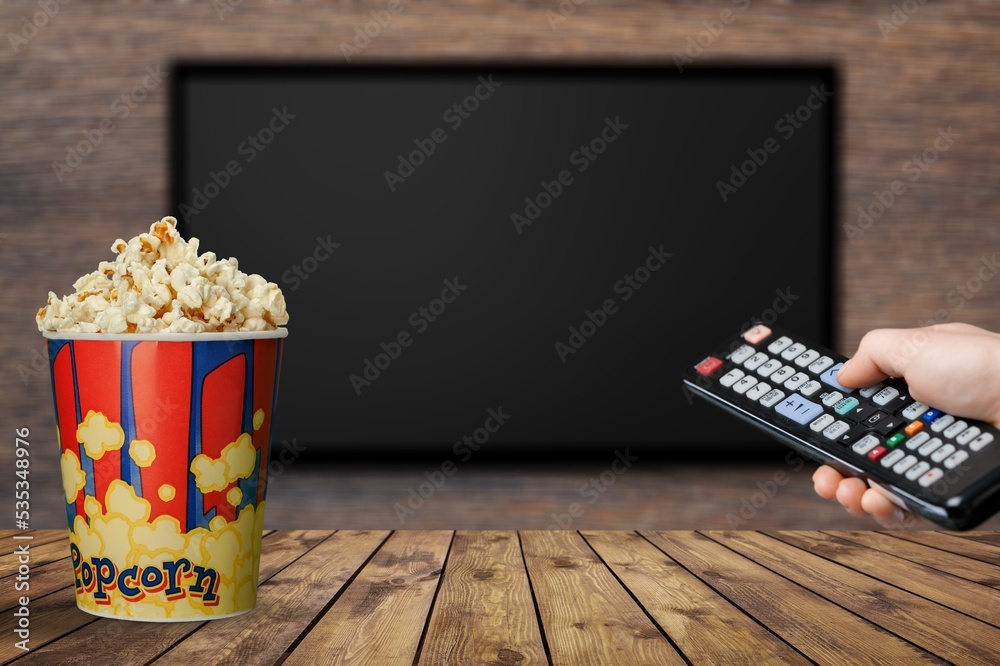Blank tv screen behind a bowl of popcorn on the desk Stock Photo ...