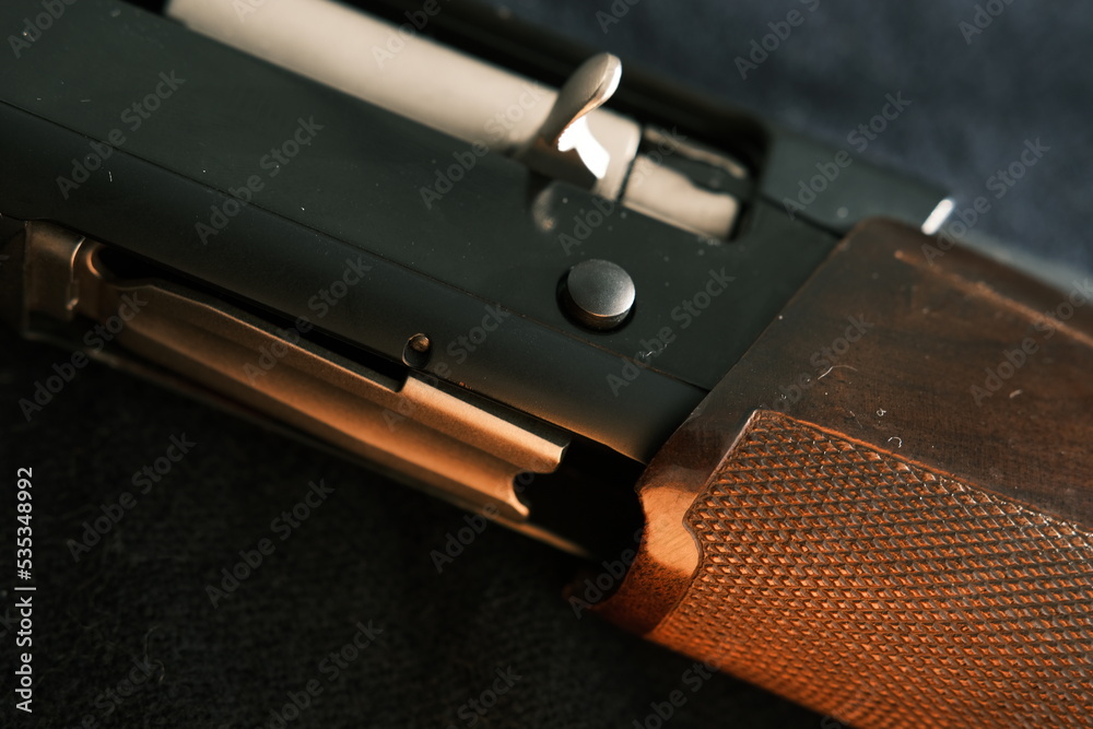 Closeup shotgun shutter. Hunting semi-automatic shotgun with wooden ...
