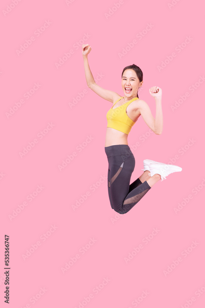 Activity asian woman jumping upwards full size on pink background ...